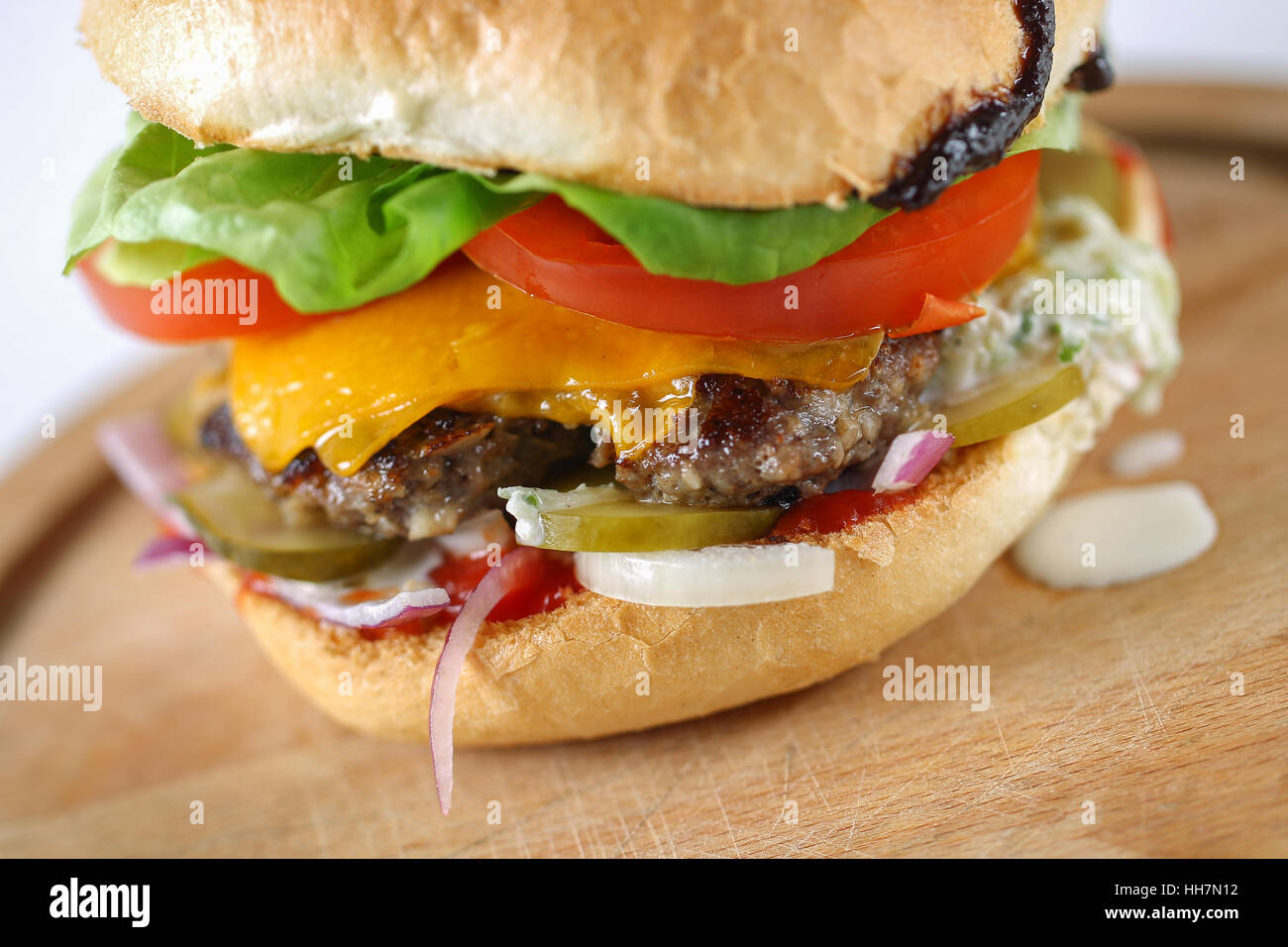 Tasty cheese beef burger with lettuce, cheddar, barbecue sauce ...