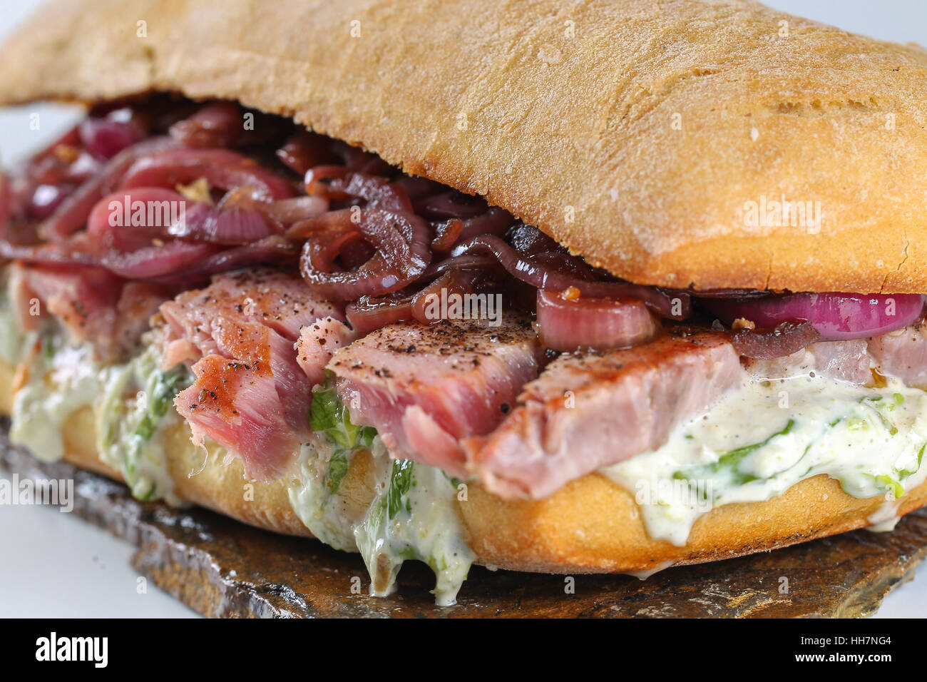 Tasty tuna steak sandwich in a ciabatta with lettuce, onions, Marie ...