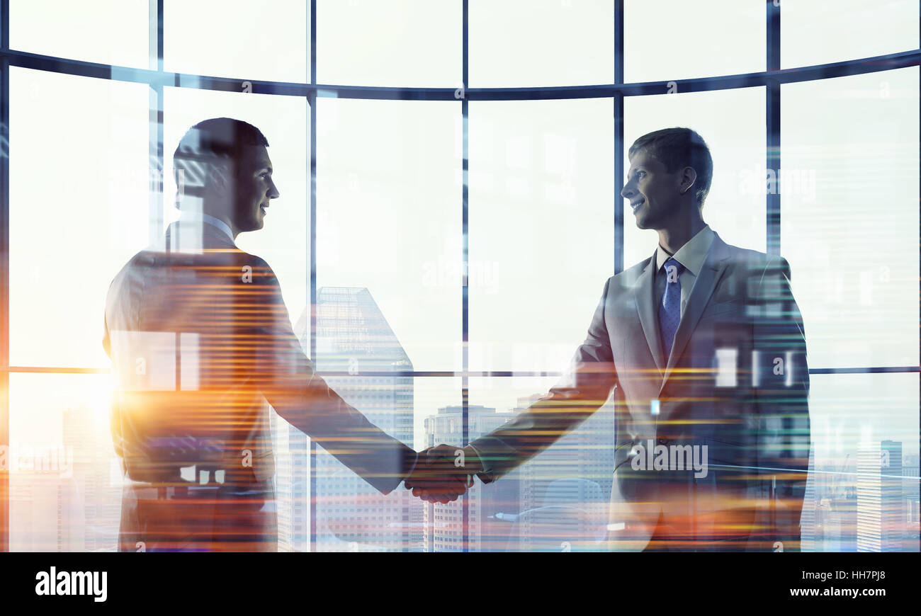 Two businessmen shaking hands to greet each other. Mixed media Stock ...