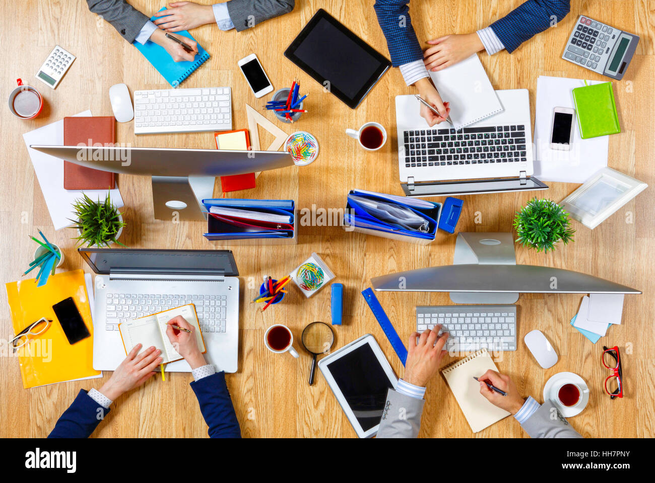Top view of office table with four colleagues working together Stock ...