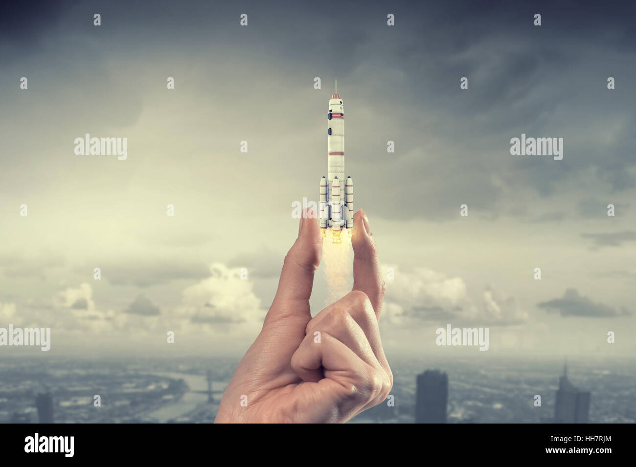 Close of hand catching flying rocket with fingers Stock Photo - Alamy