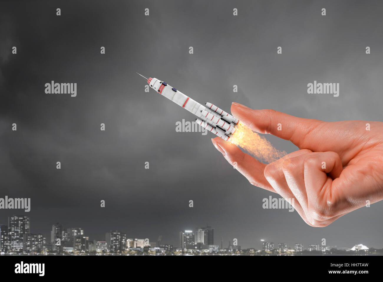Close of hand catching flying rocket with fingers Stock Photo - Alamy