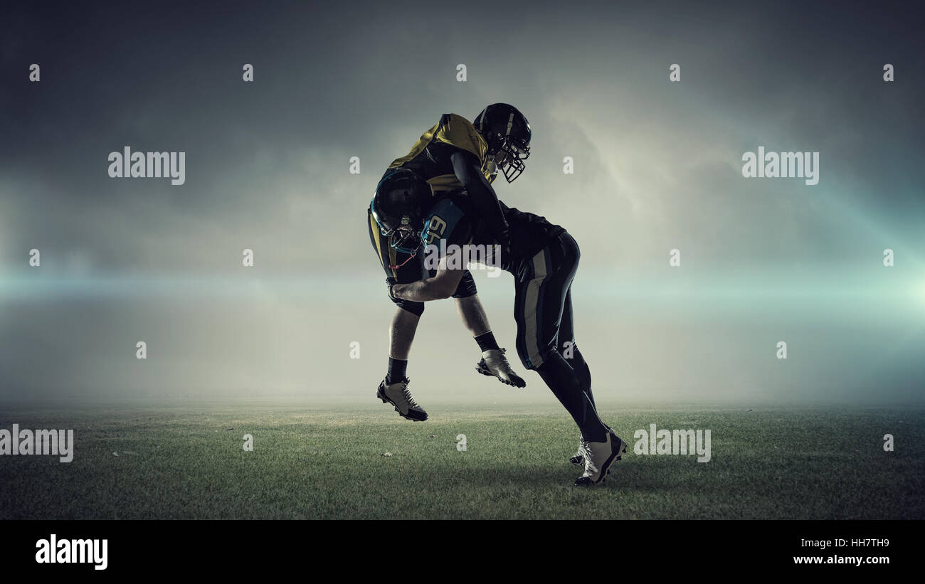 Two american football players fighting for ball Stock Photo - Alamy