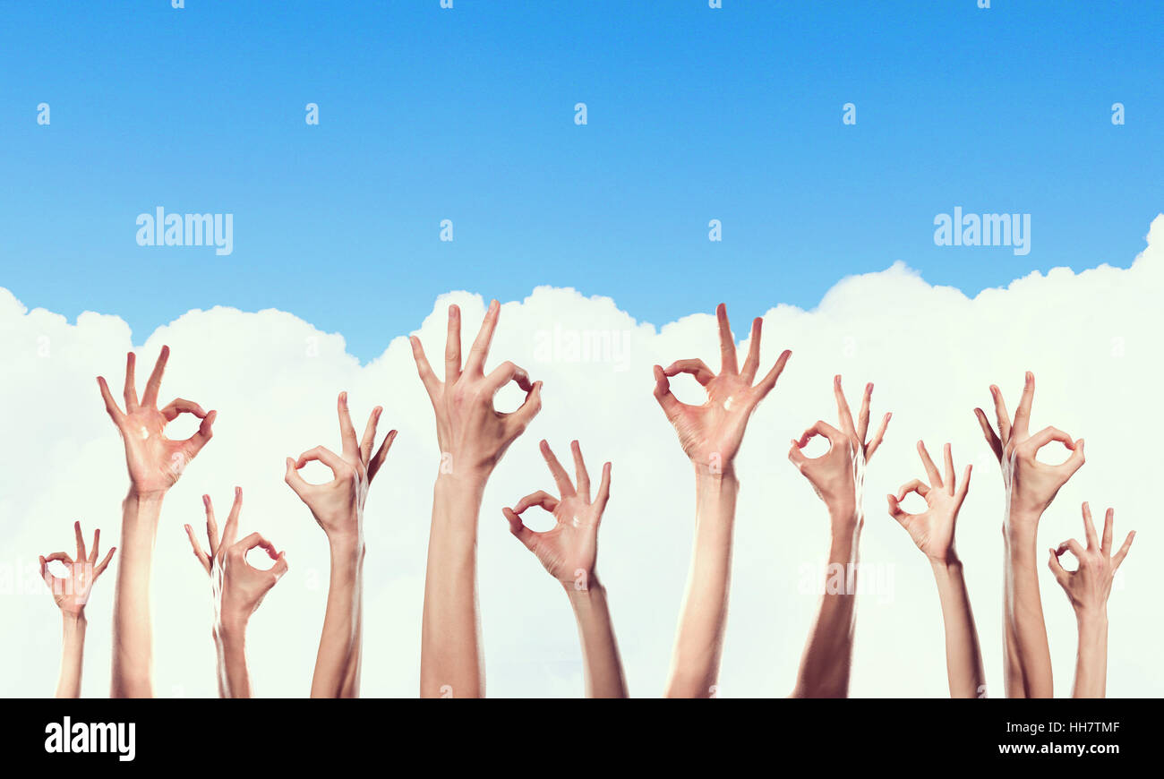 Row of raised hands showing different gestures Stock Photo - Alamy