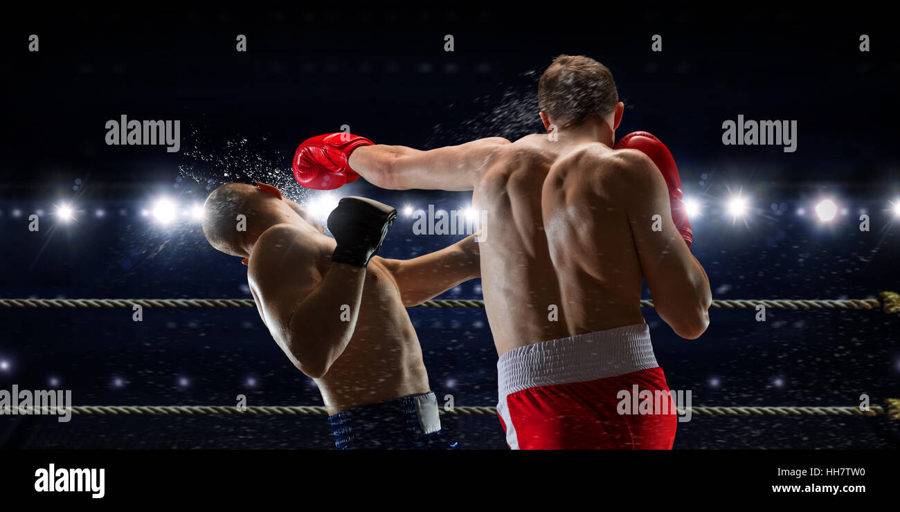 Two professional boxers fighting at sport arena. Mixed media Stock ...