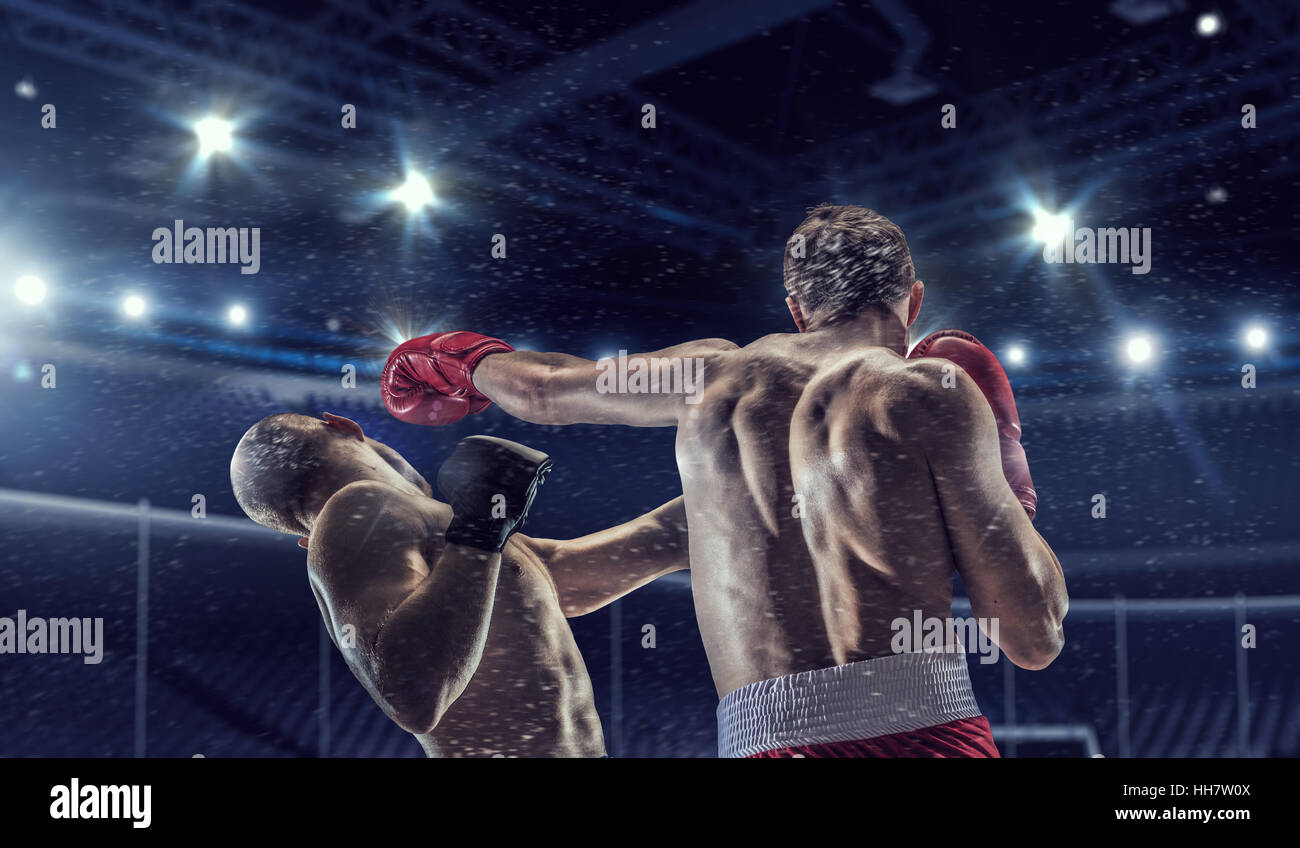 Two professional boxers fighting at sport arena. Mixed media Stock ...