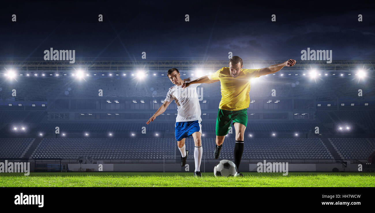 Soccer players in action on stadium fighting for ball. Mixed media ...