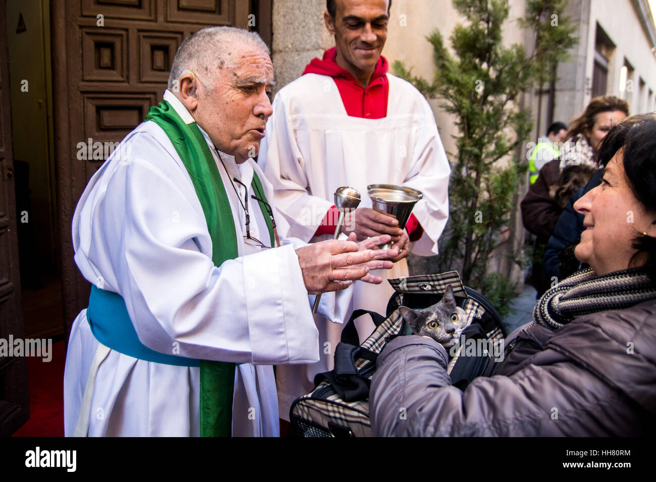 Madrid, Spain. 17th Jan, 2017. A Priest blessing a cat during the day ...