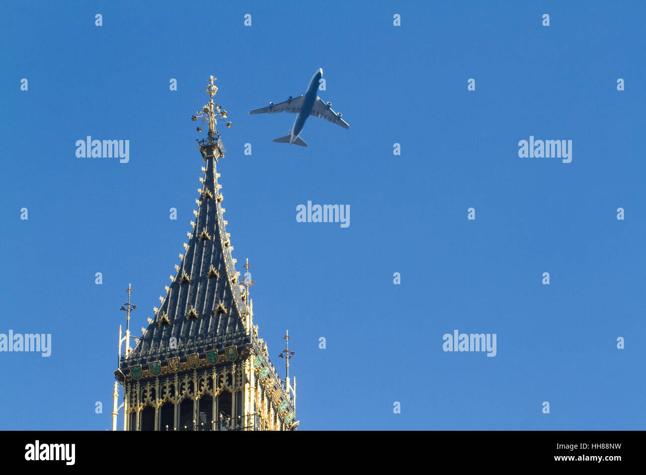 London UK. 18th January 2017. A commercial airplane flies over Big Ben ...