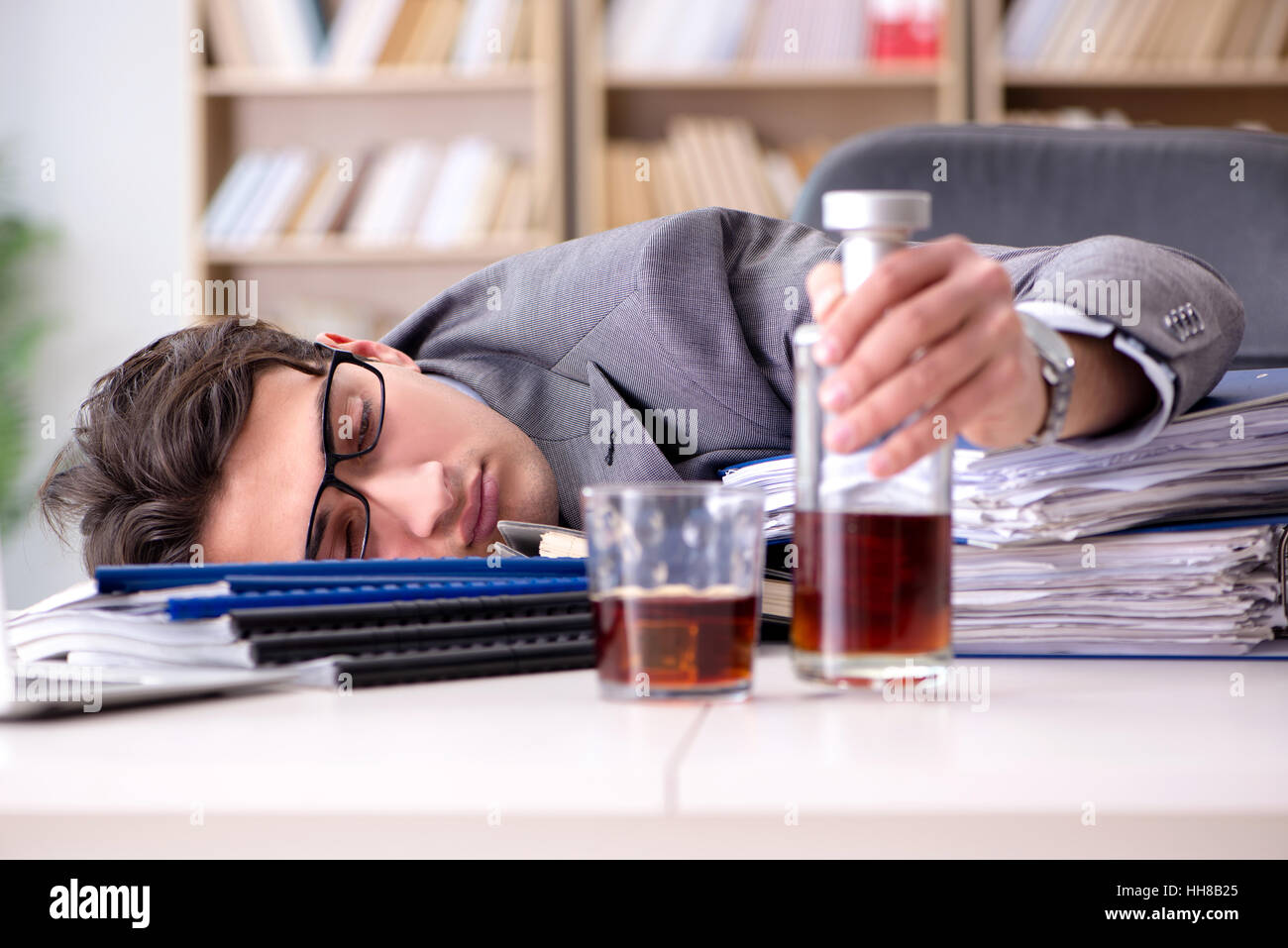 Young businessman drinking from stress Stock Photo - Alamy