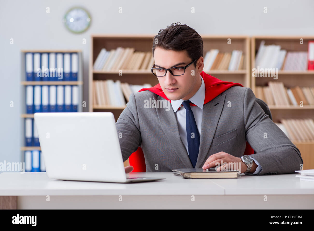 Superhero businessman working in the office Stock Photo - Alamy