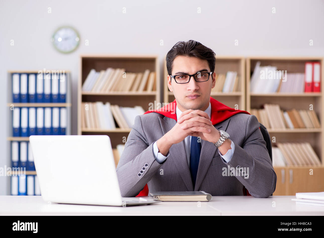 Superhero businessman working in the office Stock Photo - Alamy