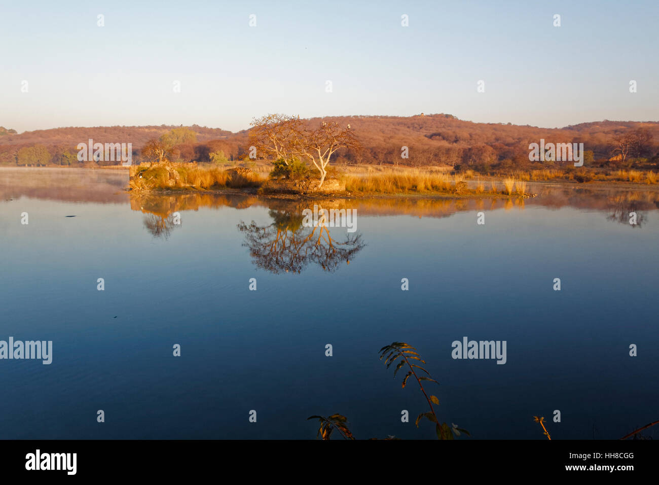 The sunrise over a lake, Padam Talab, creates a mirror image reflection ...