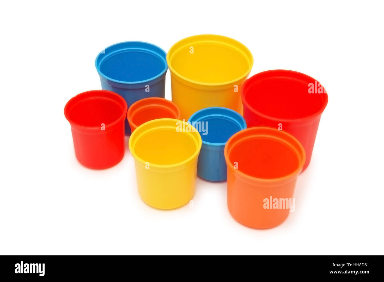 Various coloured cups isolated on white Stock Photo - Alamy