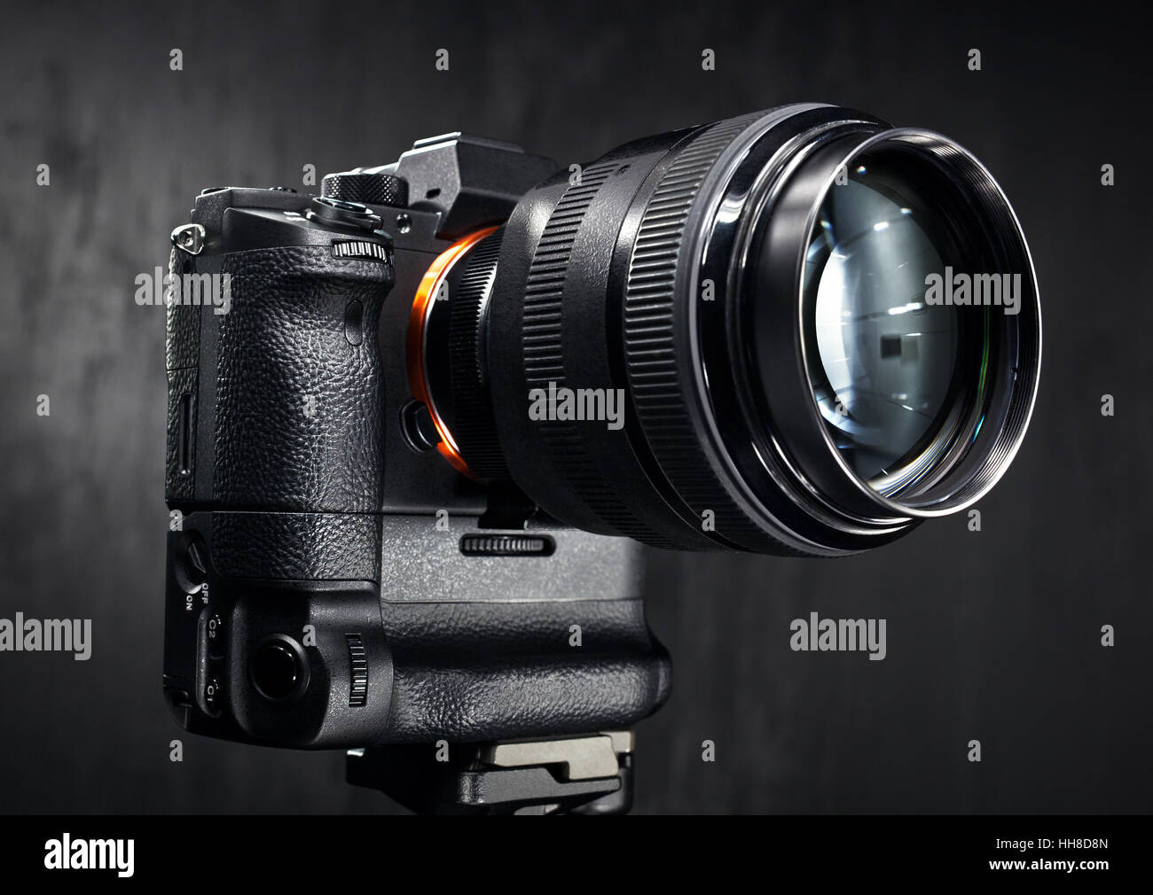 Modern digital camera with big lens on dark background Stock Photo - Alamy