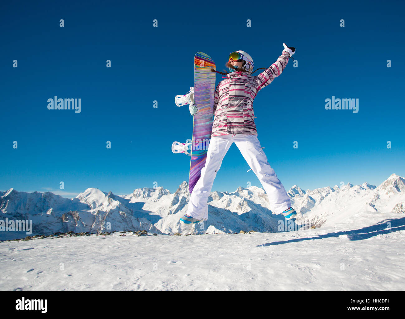 Young girl snowboarder jumping in the alpine mountains Stock Photo - Alamy