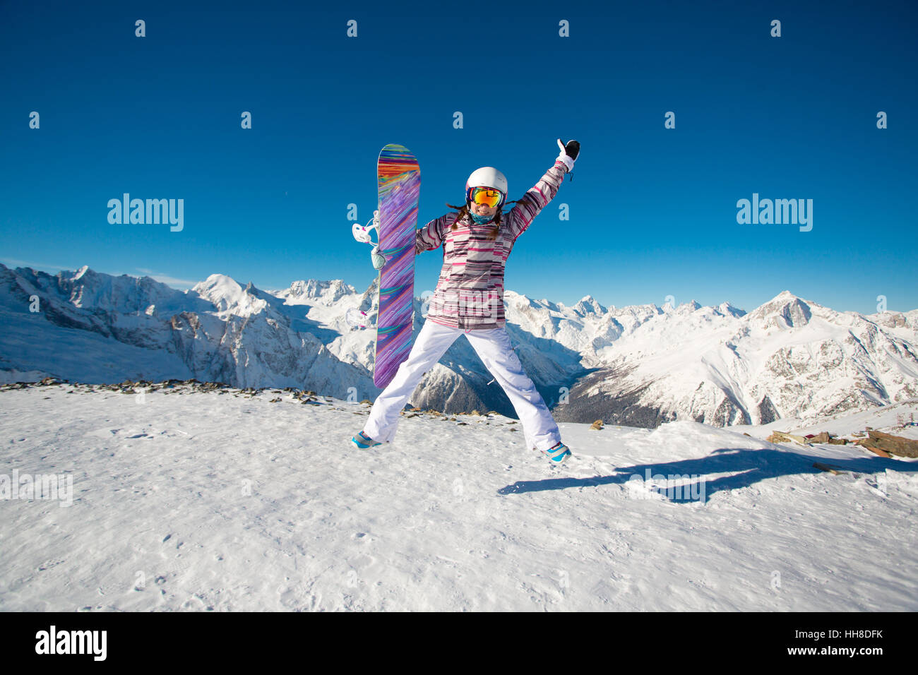 Young girl snowboarder jumping in the alpine mountains Stock Photo - Alamy