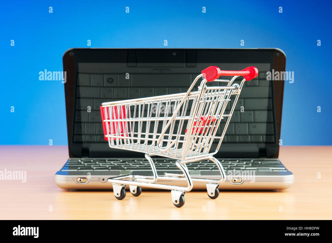 Shopping online with computer and cart Stock Photo - Alamy