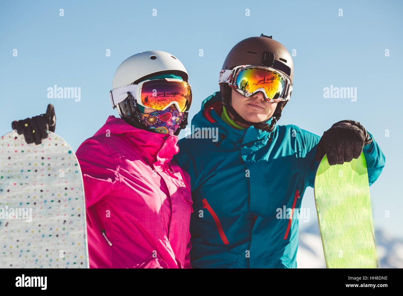 Happy couple of snowboarders in the alpine mountains Stock Photo - Alamy
