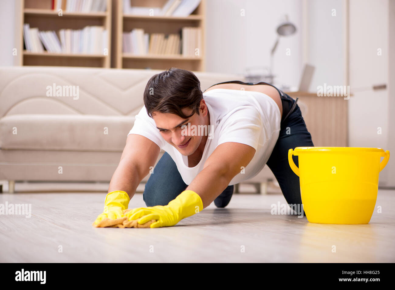 Man husband cleaning the house helping wife Stock Photo - Alamy