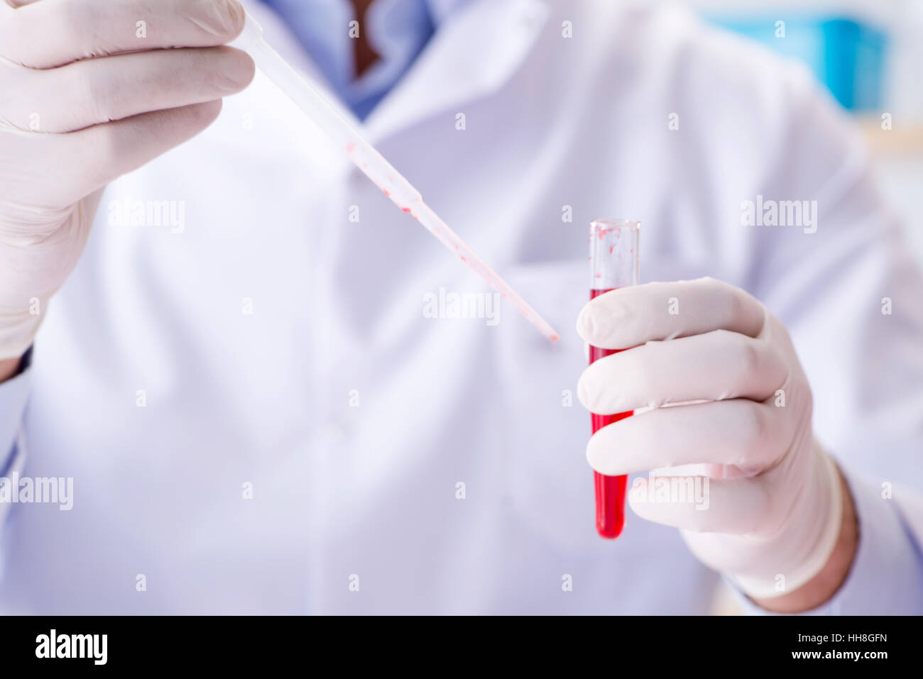Blood testing in the lab with young scientist Stock Photo - Alamy