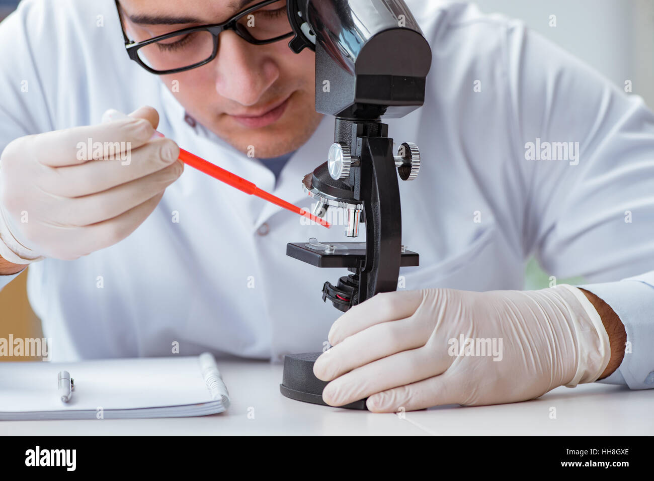 Young doctor doing the blood test Stock Photo - Alamy