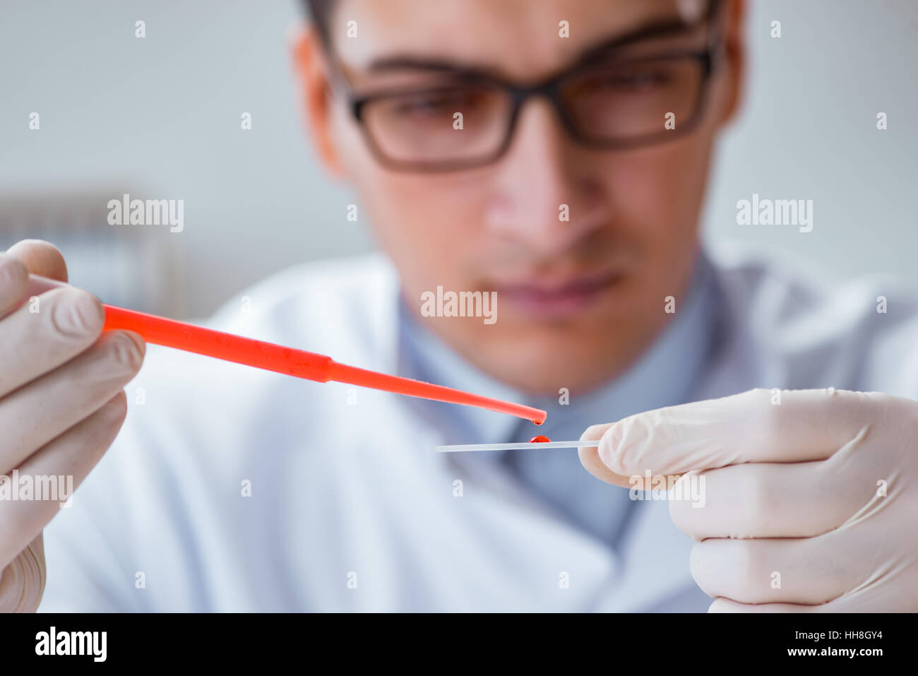 Young doctor doing the blood test Stock Photo - Alamy