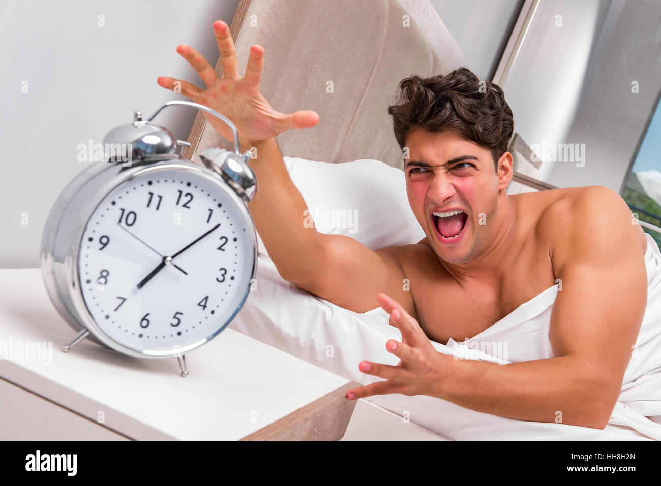 Man having trouble waking up in the morning Stock Photo - Alamy