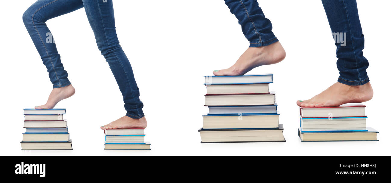 Student stepping on stack of books Stock Photo - Alamy