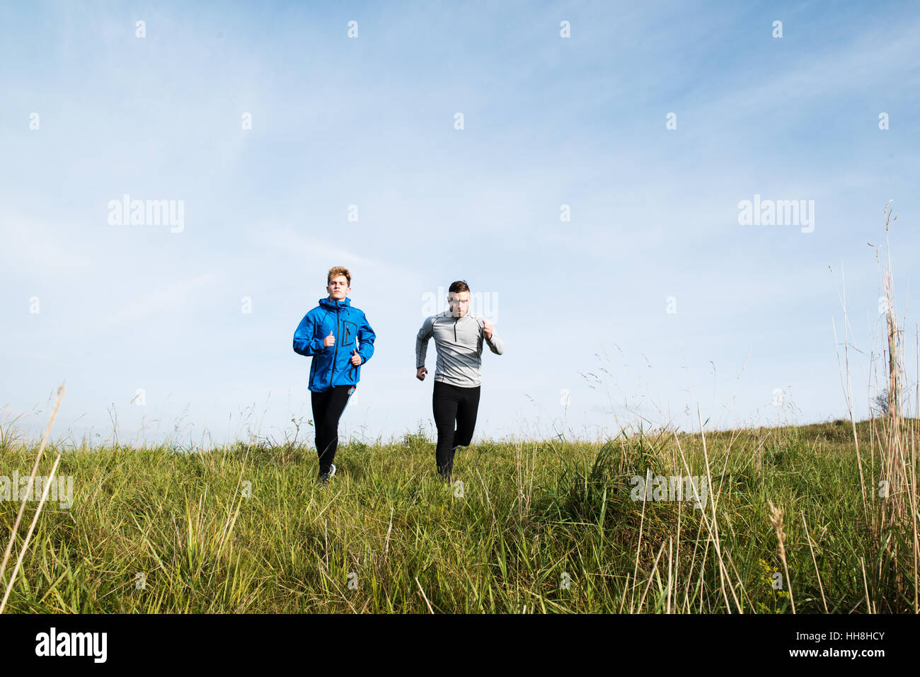 Two young hipster athletes running in sunny autumn nature Stock Photo ...