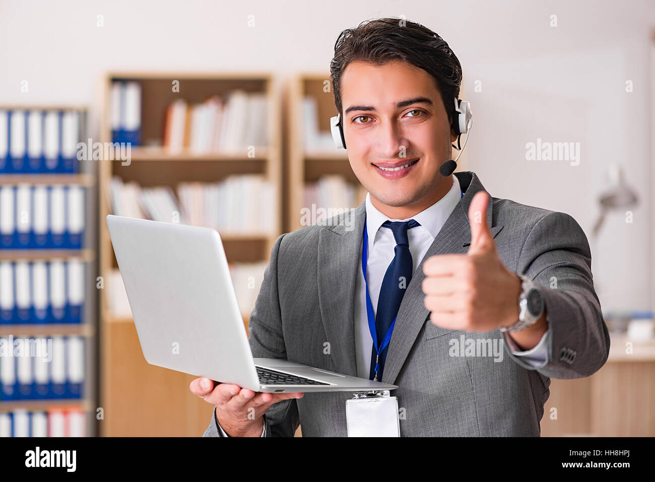 Handsome customer service clerk with headset Stock Photo - Alamy