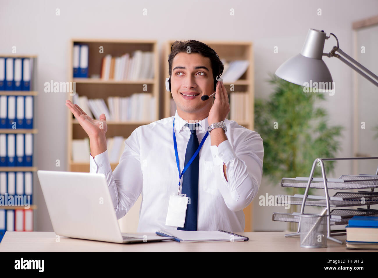Handsome customer service clerk with headset Stock Photo - Alamy