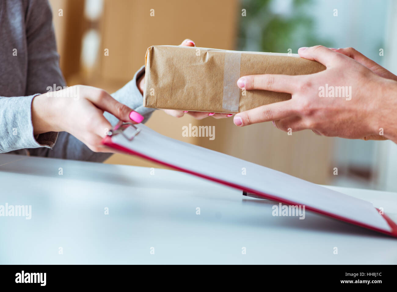 Delivery man delivering parcel box Stock Photo - Alamy