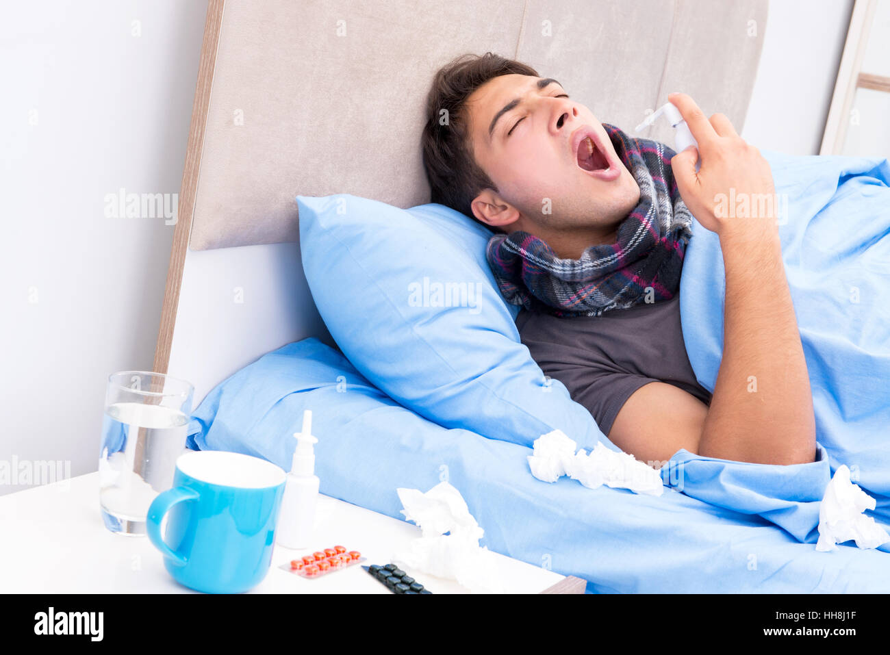 Sick man with flu lying in the bed Stock Photo - Alamy