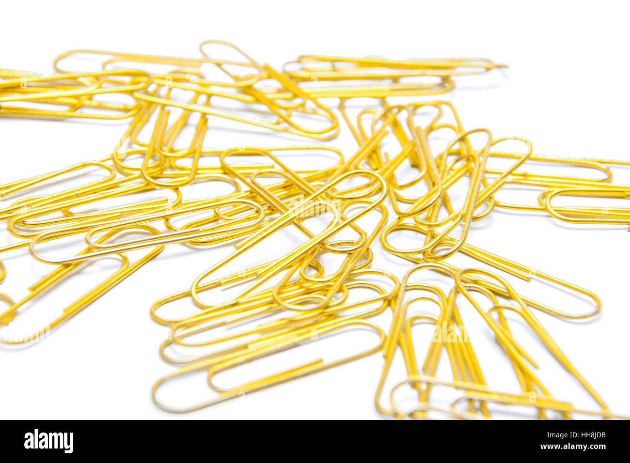 Gold clip for documents scattered on a white background isolated many ...