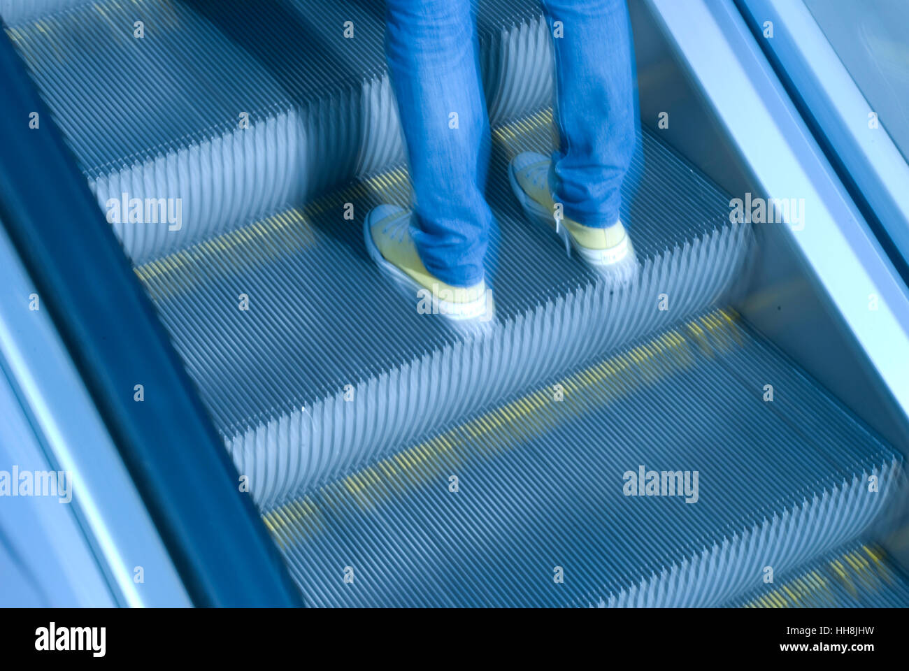 A person with yellow sportive shoes in the mechanical escalators Stock ...