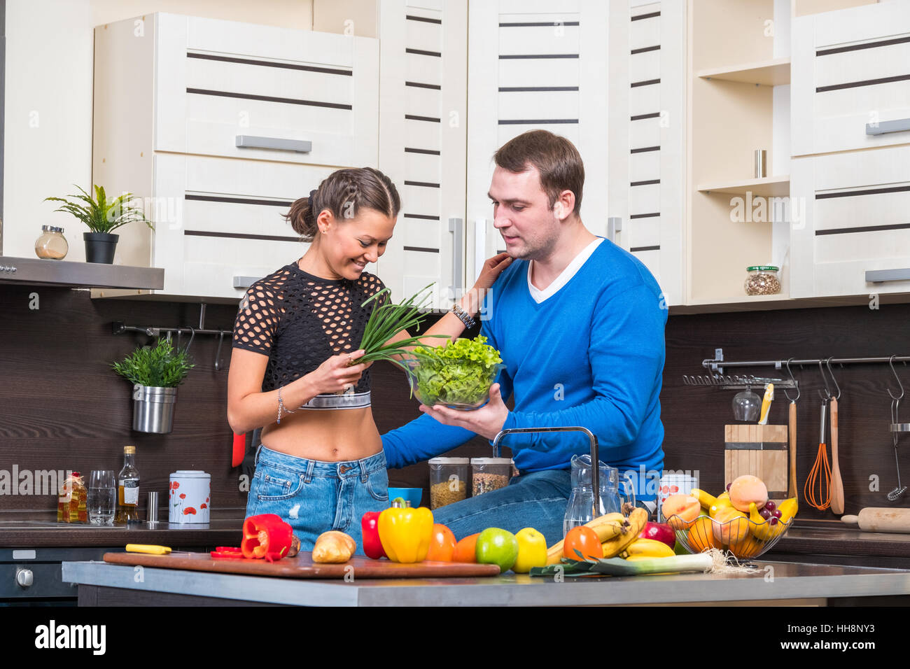 Young couple having fun in the kitchen Stock Photo - Alamy