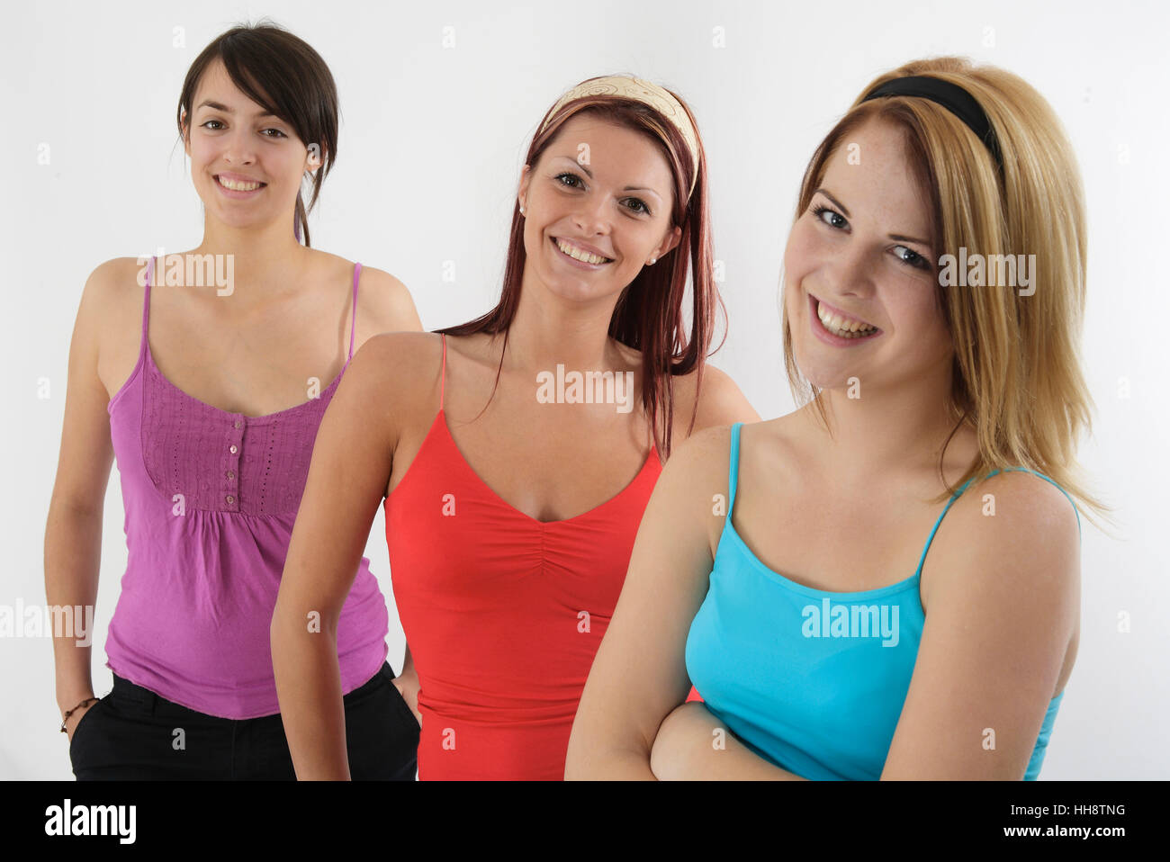 Three young women with colorful clothes Stock Photo - Alamy