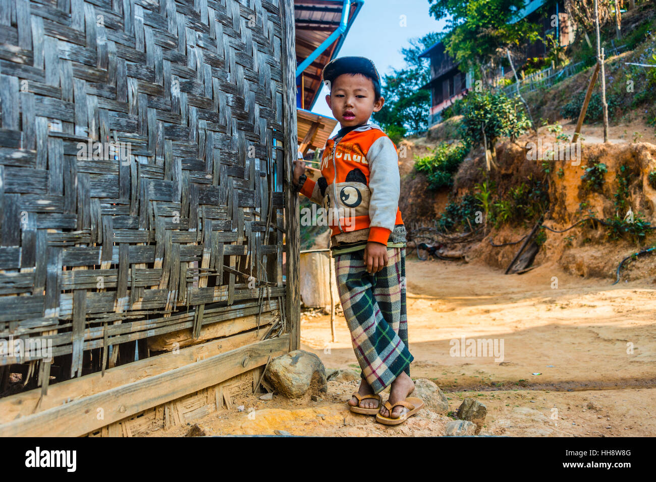 Little boy stands in front of log cabin, Palaung hilltribe, Palaung ...