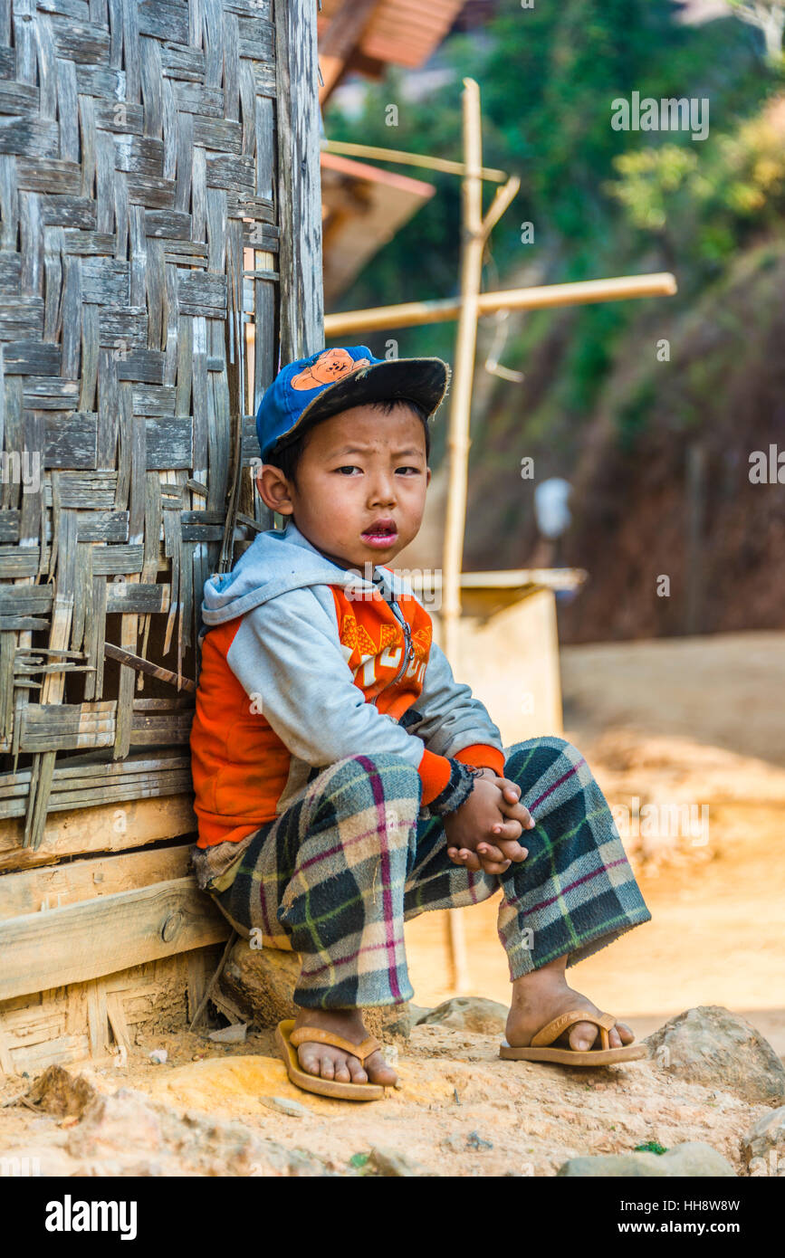 Little boy sitting in front of log cabin, Palaung hilltribe, Palaung ...