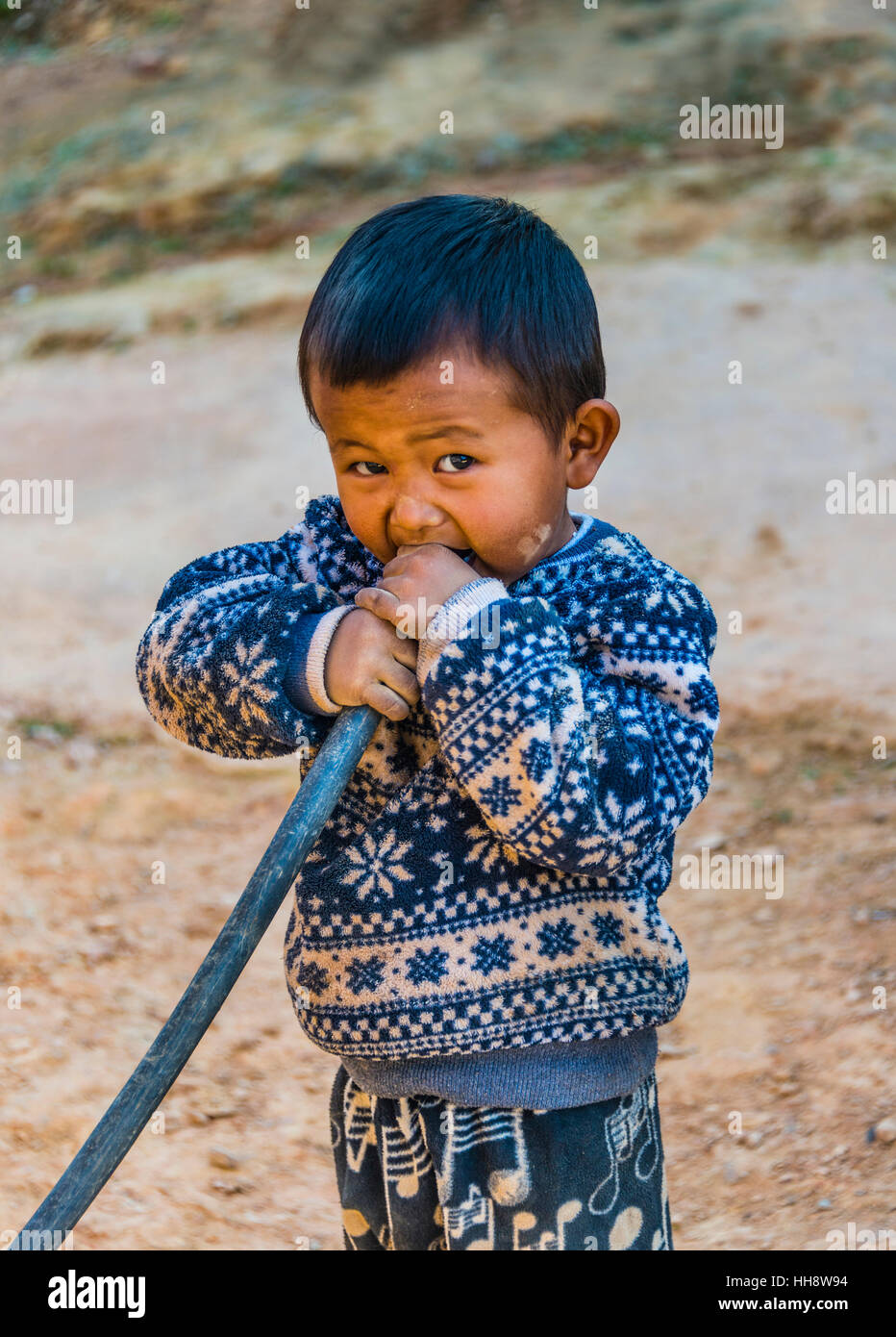 Little boy blowing into hose, Palaung hilltribe, Palaung Village in ...