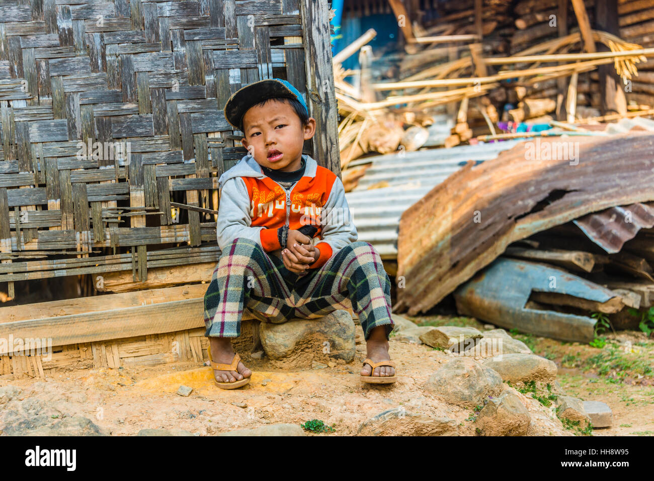 Little boy sitting in front of log cabin, Palaung hilltribe, Palaung ...