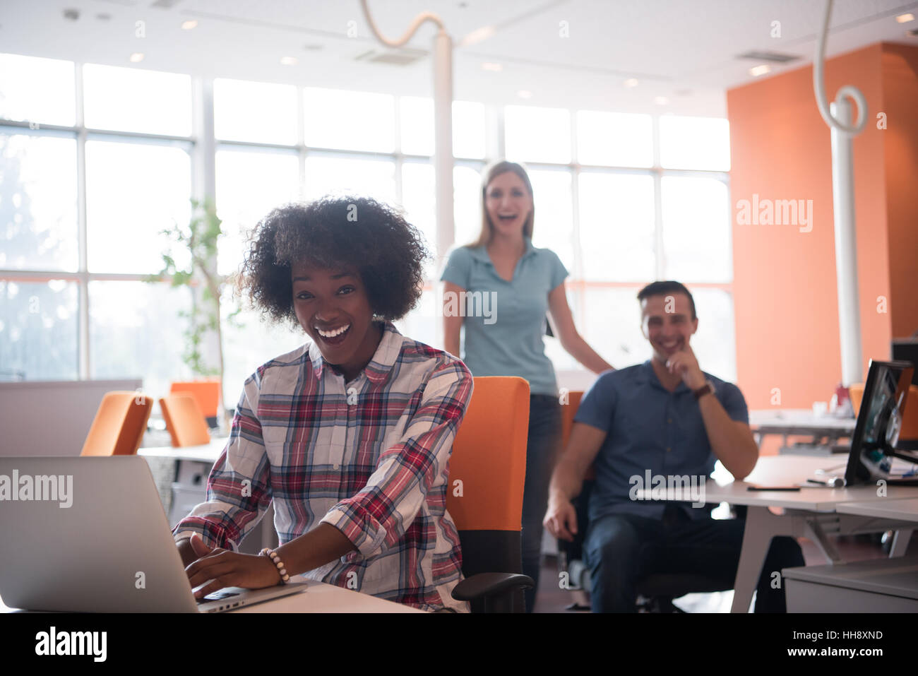 young smiling African American informal businesswoman working in the ...