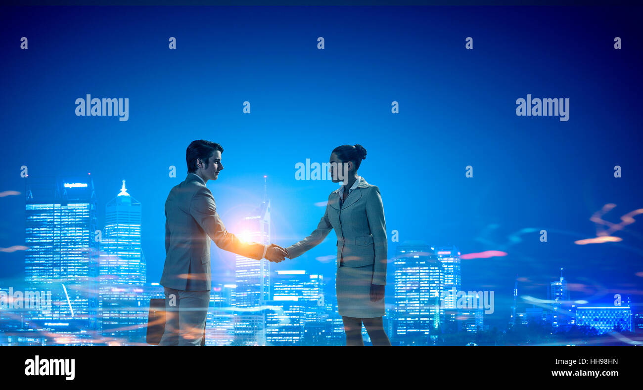 Business handshake with night scene city in background Stock Photo - Alamy