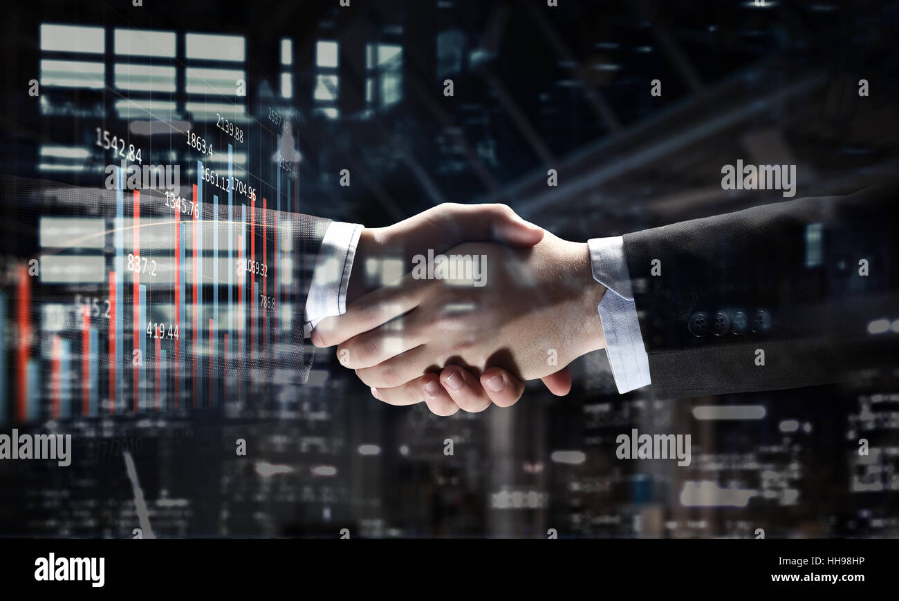 Close up of business handshake against office interior background ...