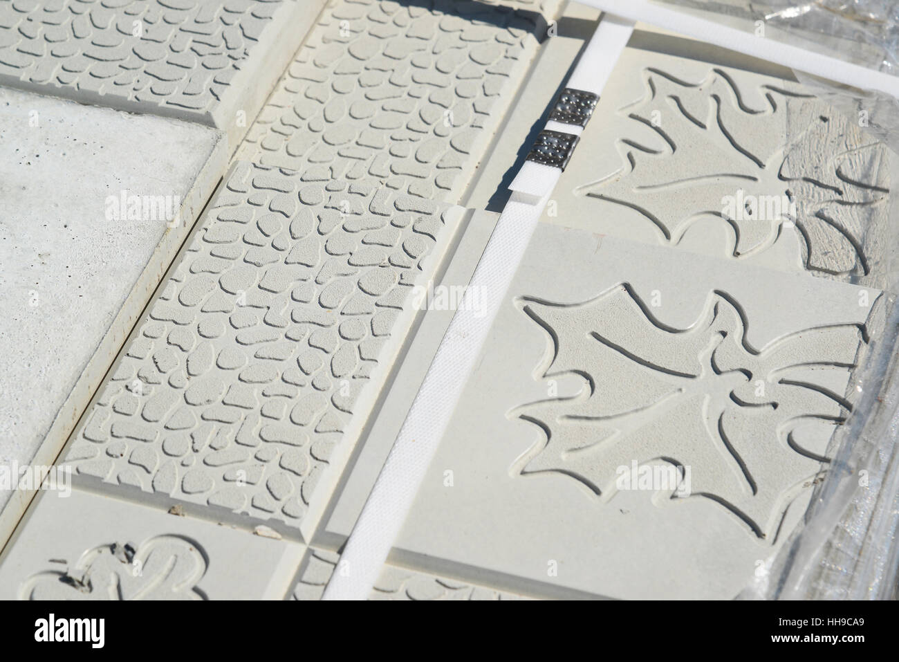 pavement tile with pattern in the form of a maple leaf Stock Photo - Alamy