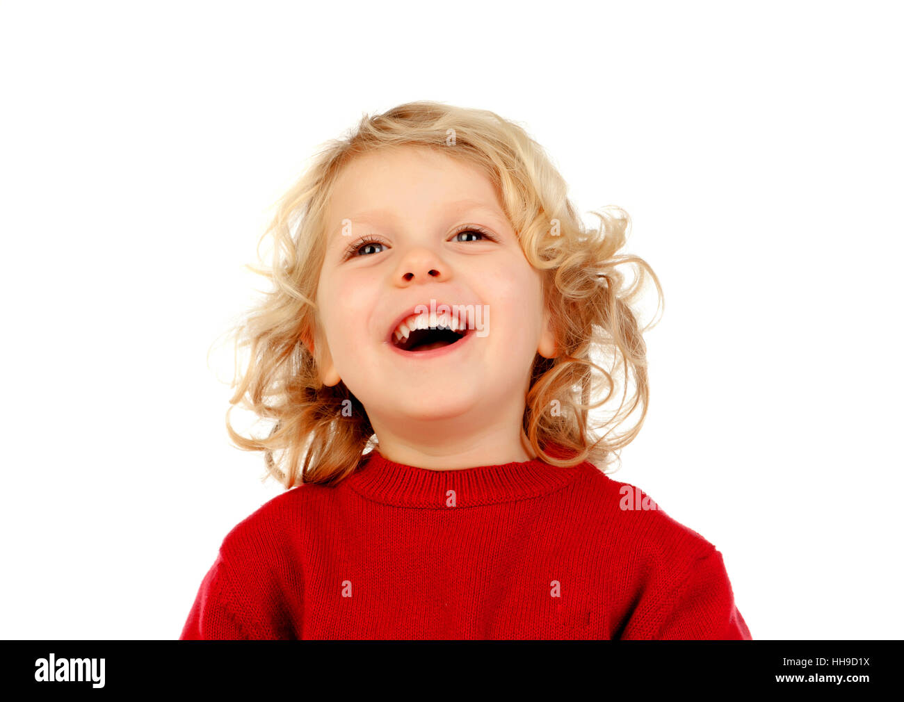 Portrait of playful small kid with long blond hair looking back ...