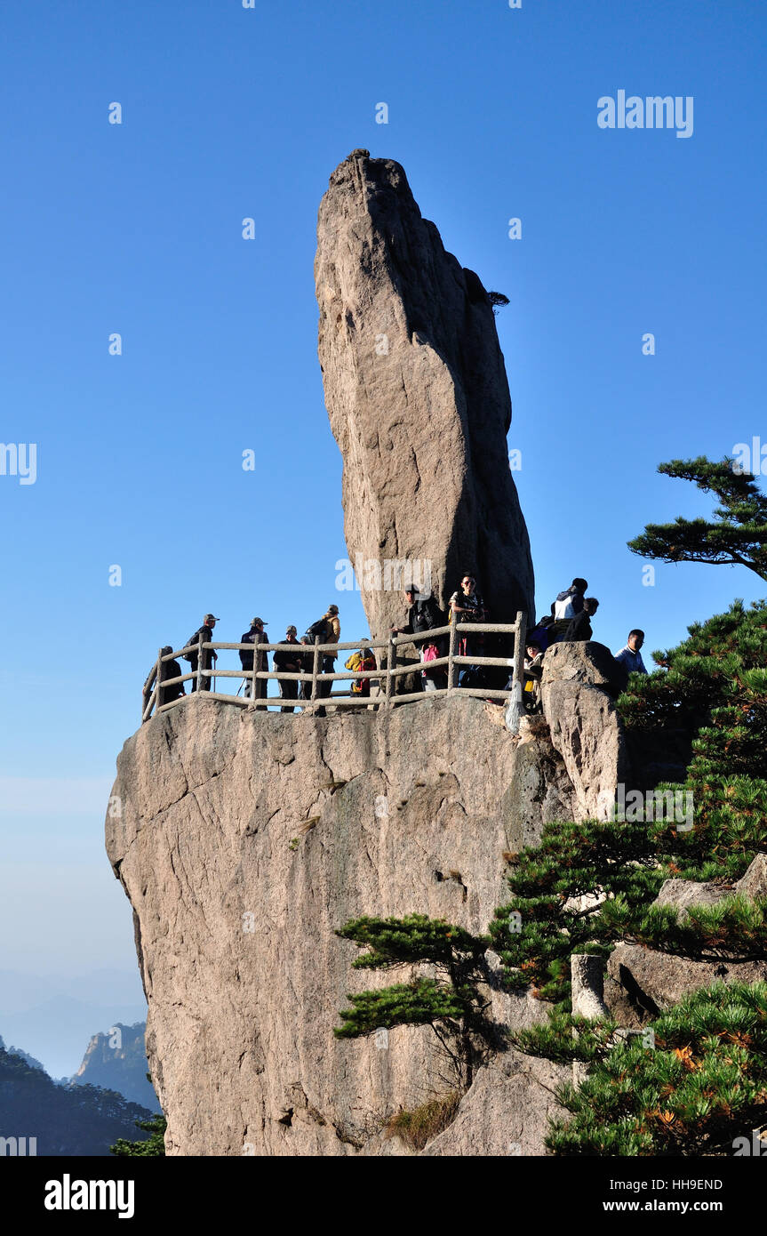 Tourists near a landmark rock on top of the Huangshan Yellow Mountain ...