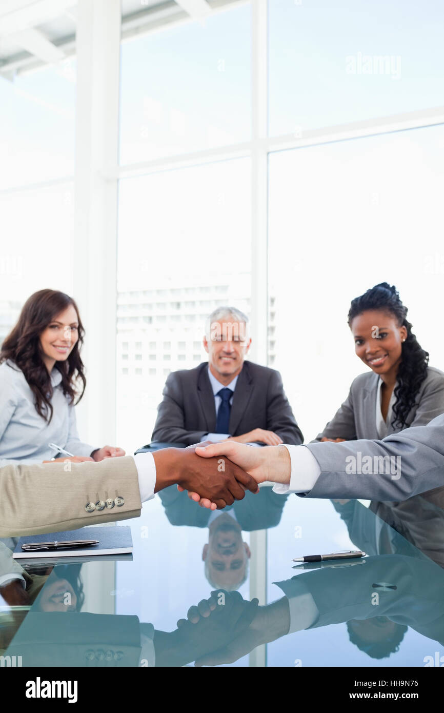 Friendly handshake between two colleagues during a meeting Stock Photo ...