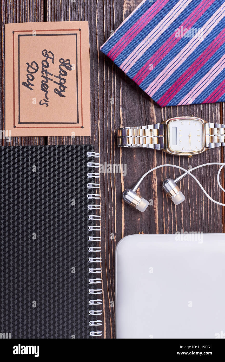 Notebook, striped tie and watch Stock Photo - Alamy